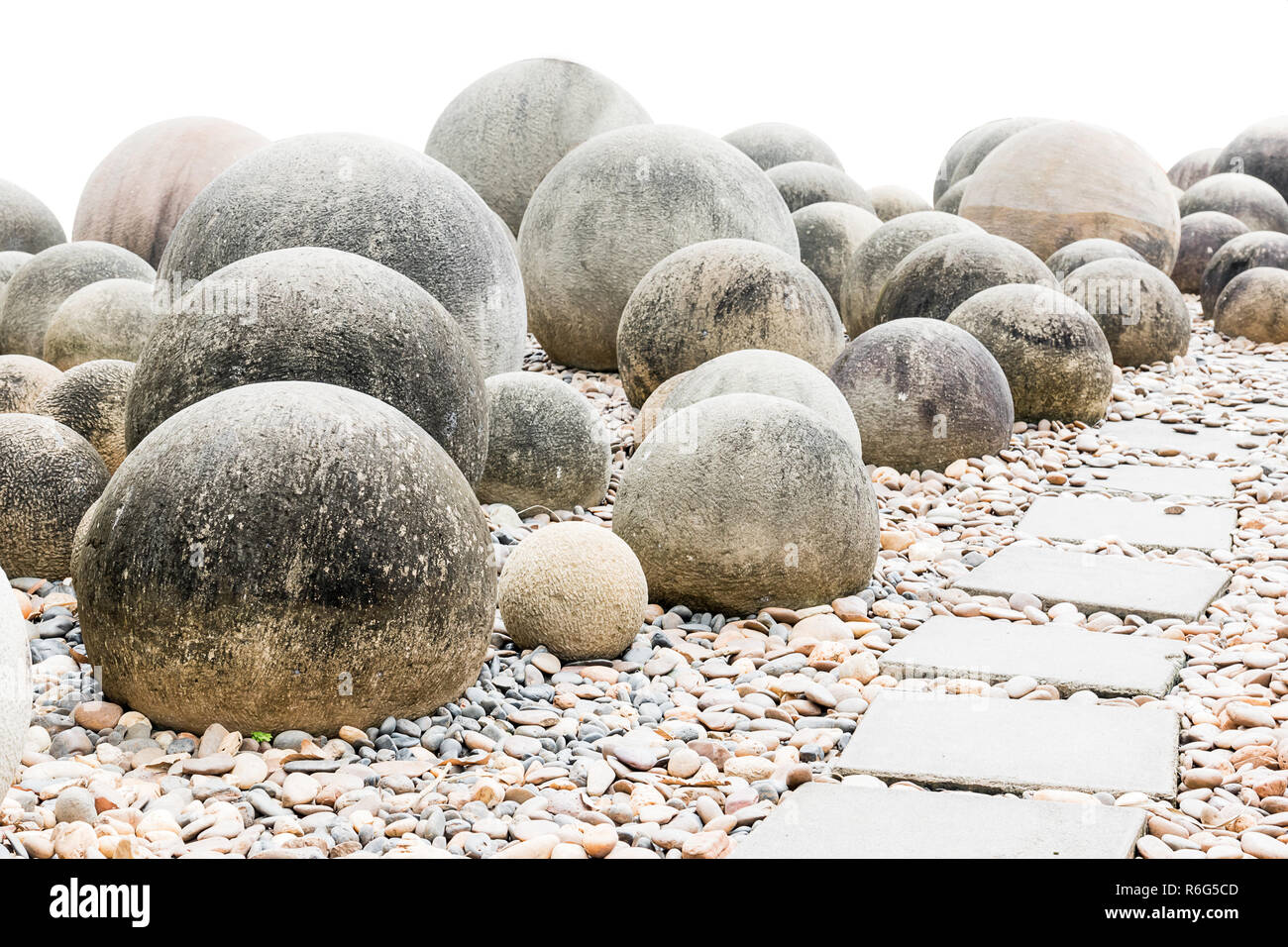Stone sphere in garden with footpath Stock Photo - Alamy