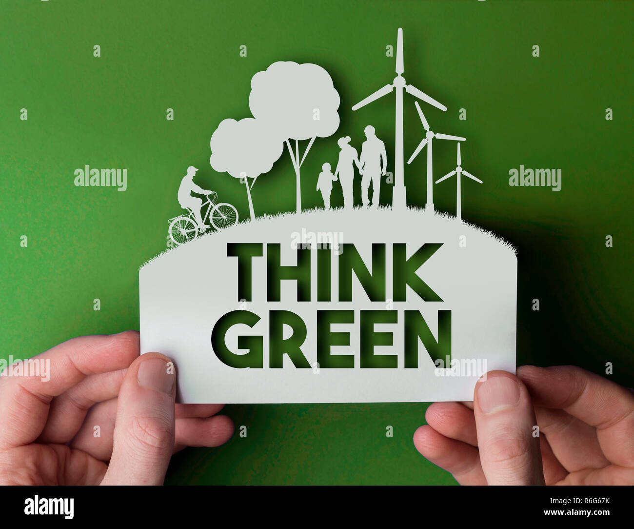 Think green - green environmental paper background with wind turbines ...