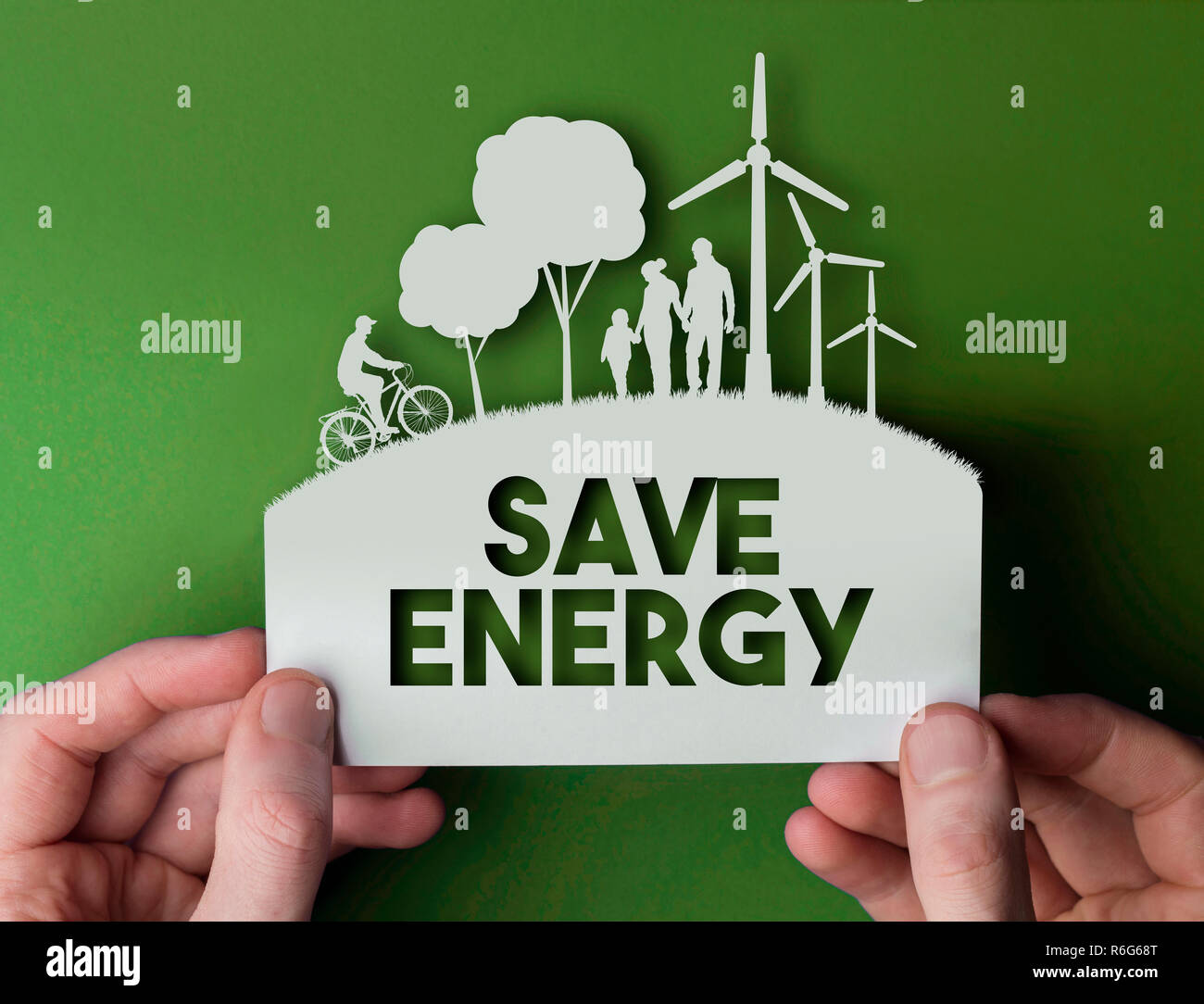 Save energy - green environmental paper background with wind turbines ...