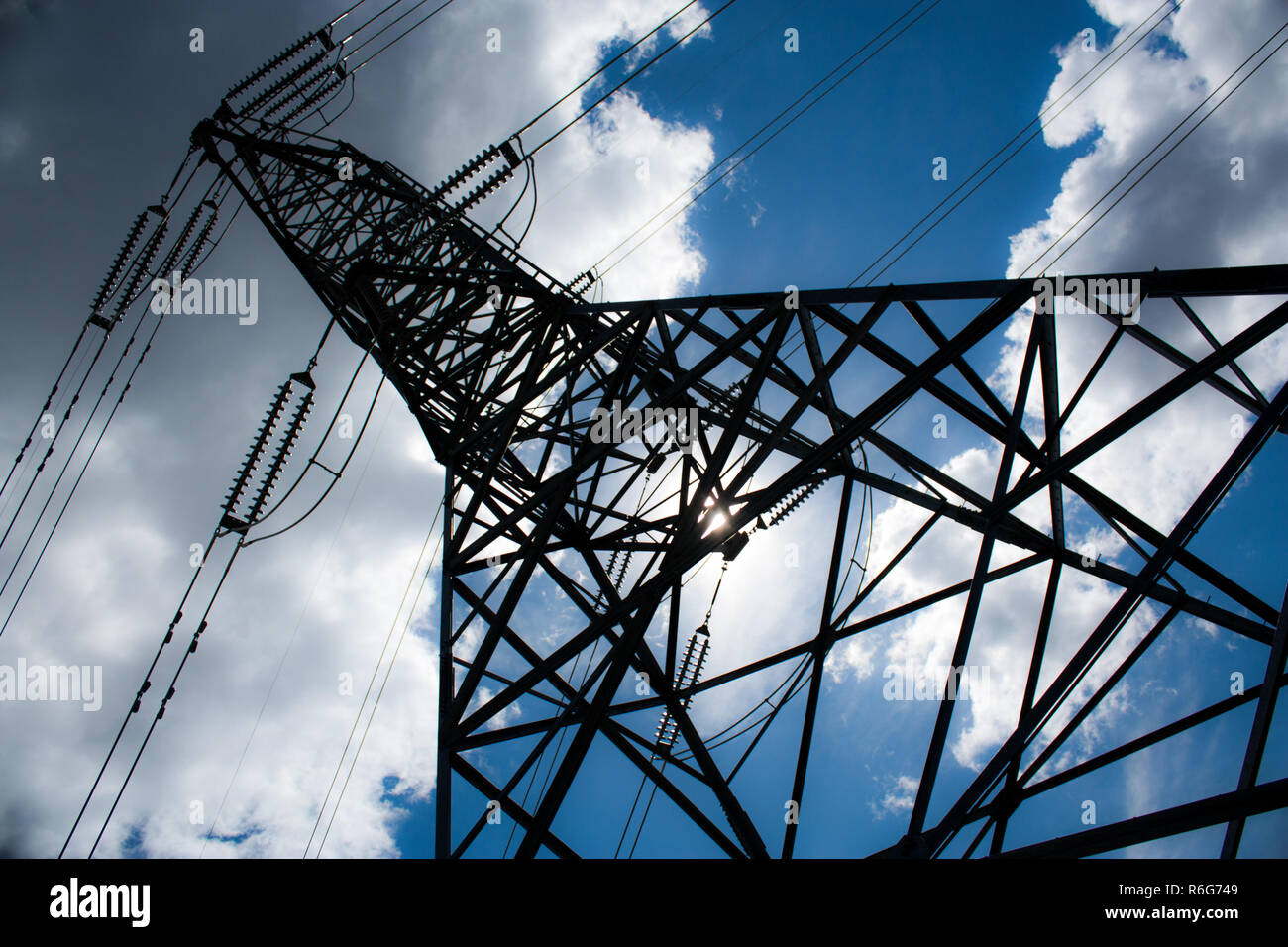 Power line tower taken at an unusual perspective with blue sky and ...
