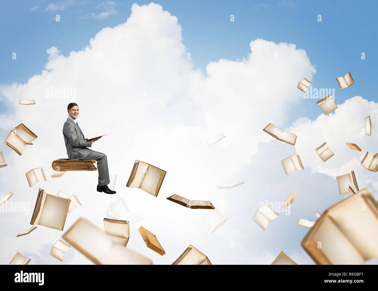 Man reading book and many of them flying in air Stock Photo - Alamy