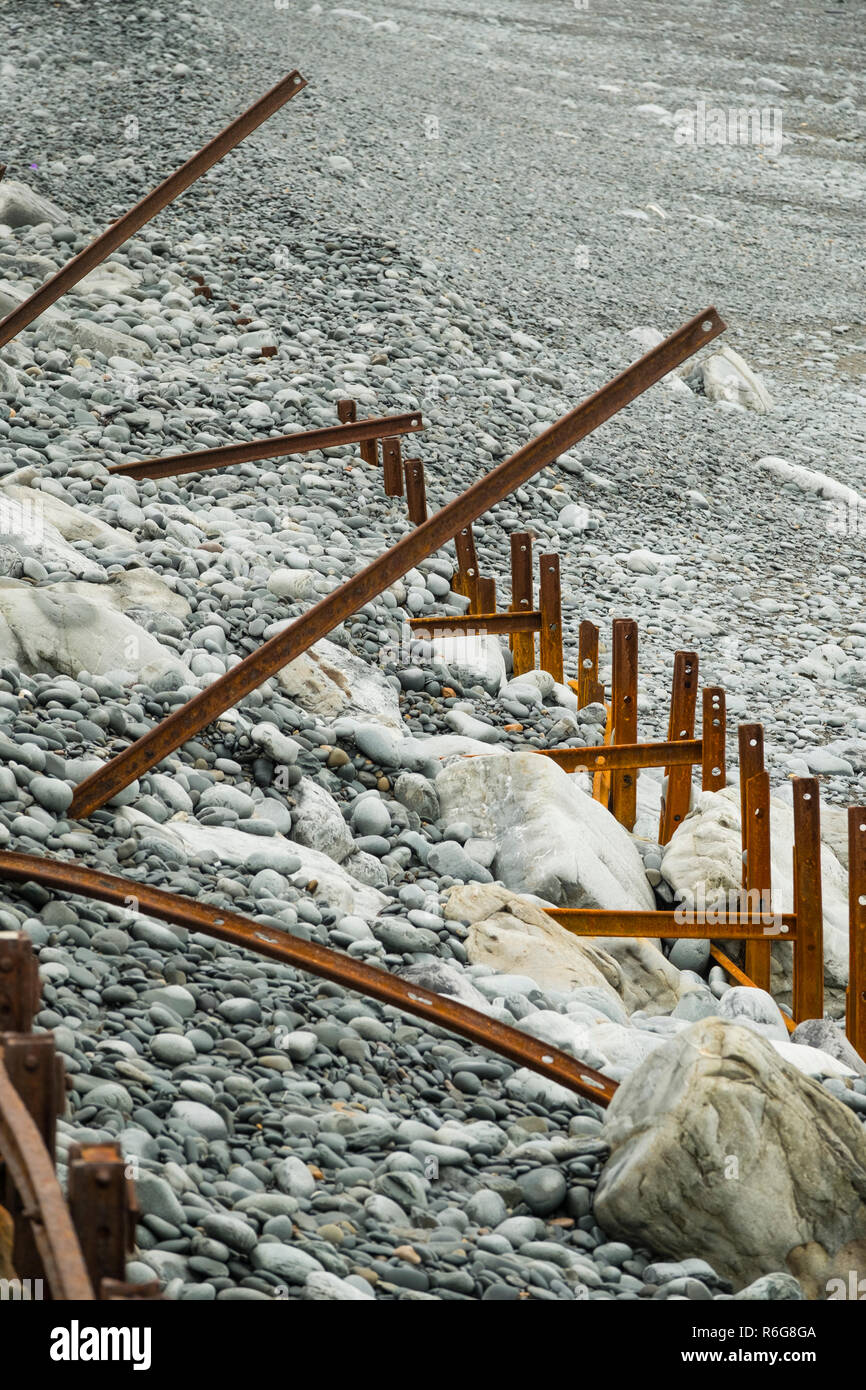 Coastal Erosion in the UK Twisted mangled metal and boulder sea ...