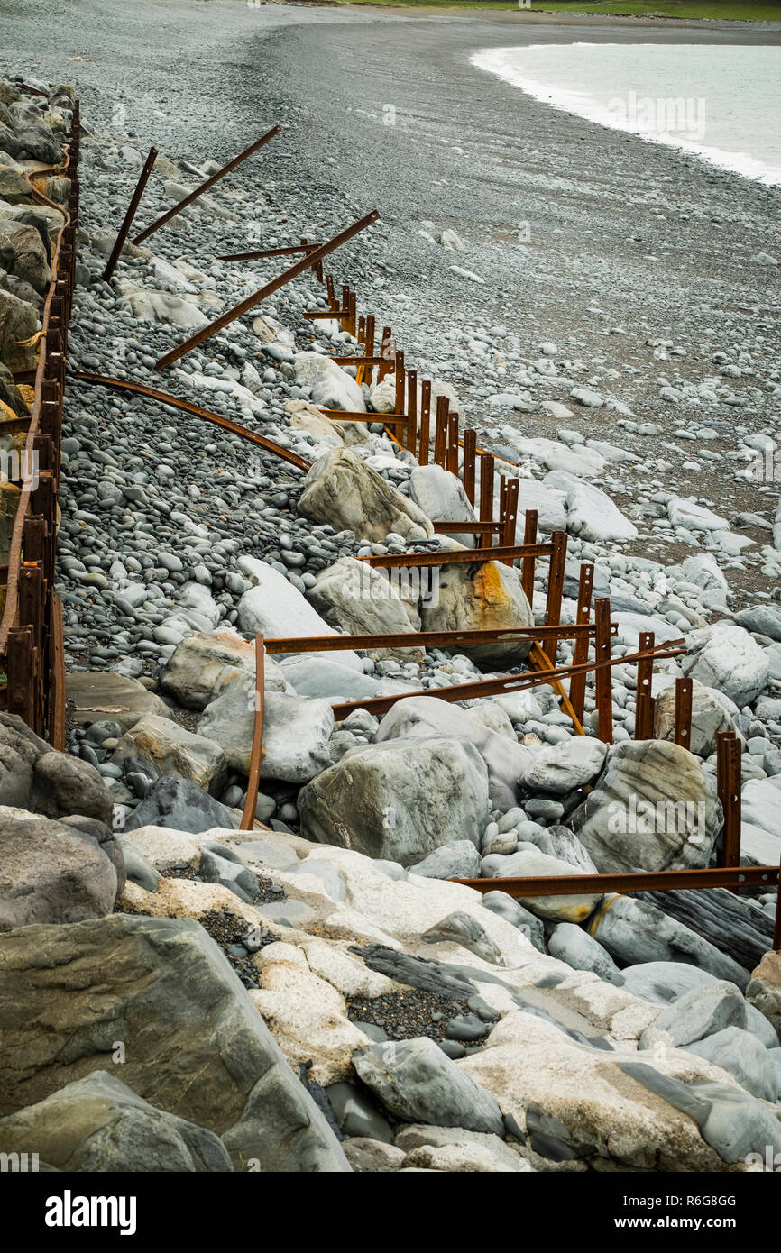 Coastal Erosion in the UK Twisted mangled metal and boulder sea ...