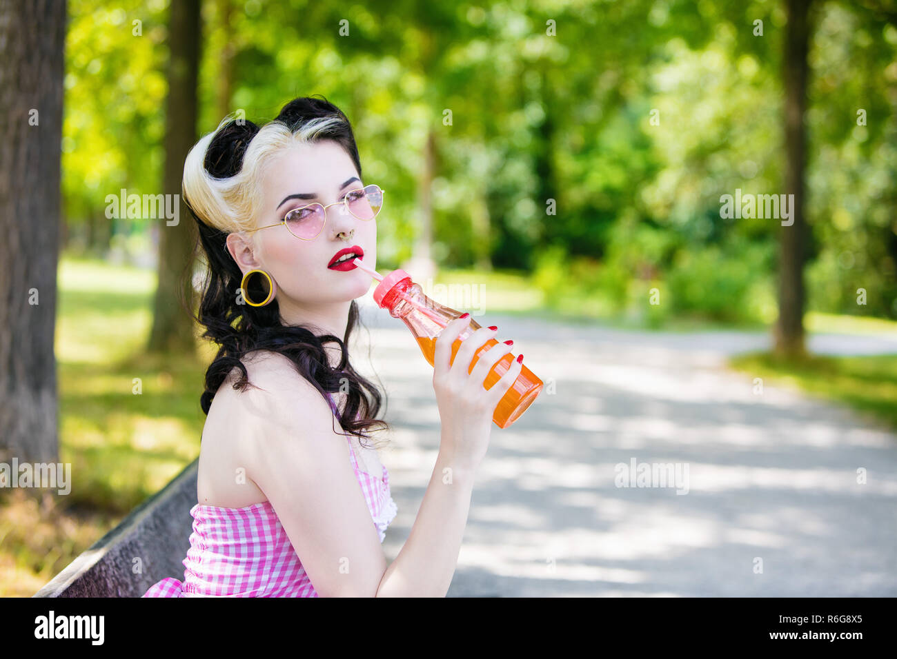 Portrait of a young Pin'Up in profile drinking a soda Stock Photo - Alamy
