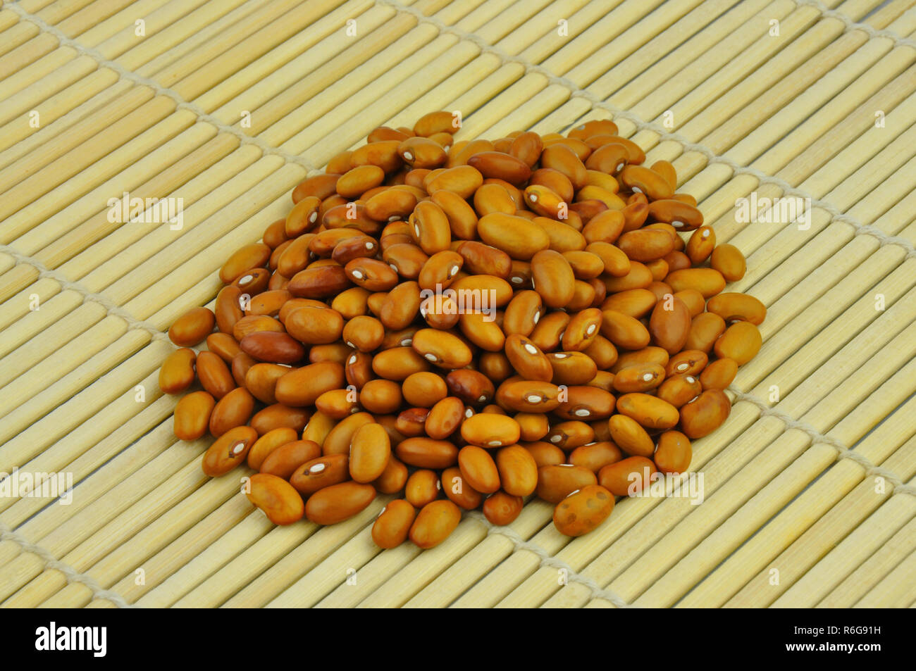 Orange beans on bamboo mat Stock Photo - Alamy