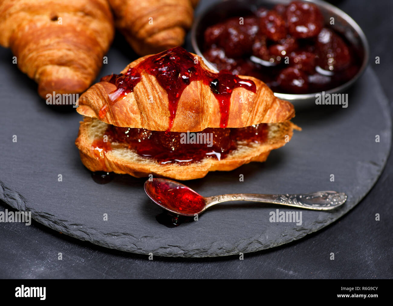 baked croissant with strawberry jam Stock Photo - Alamy
