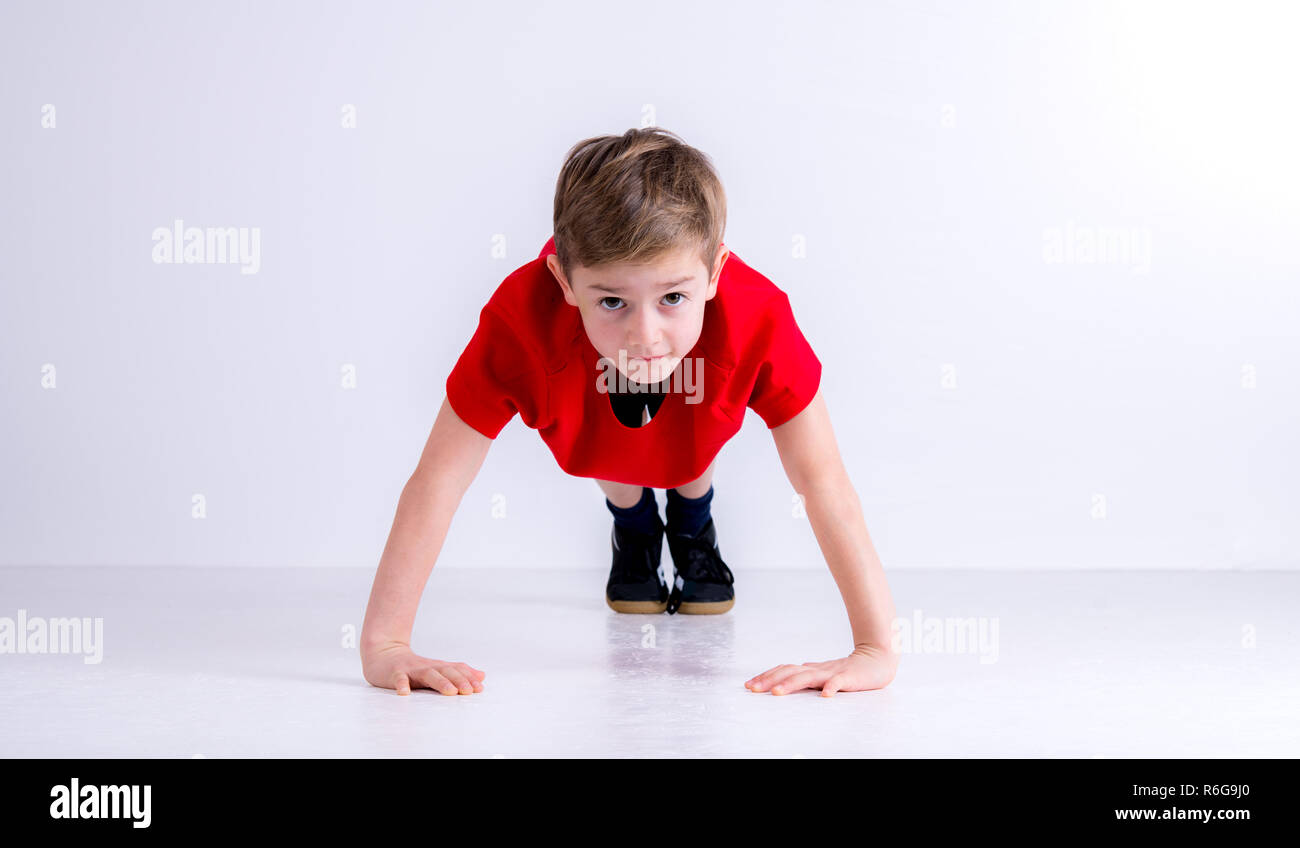 boy in red shirt doing push- ups Stock Photo - Alamy