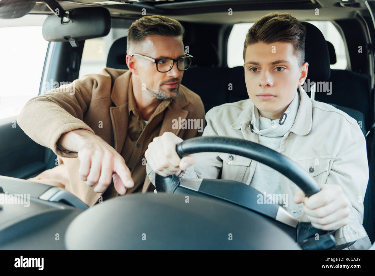 Father And Teenage Son Driving