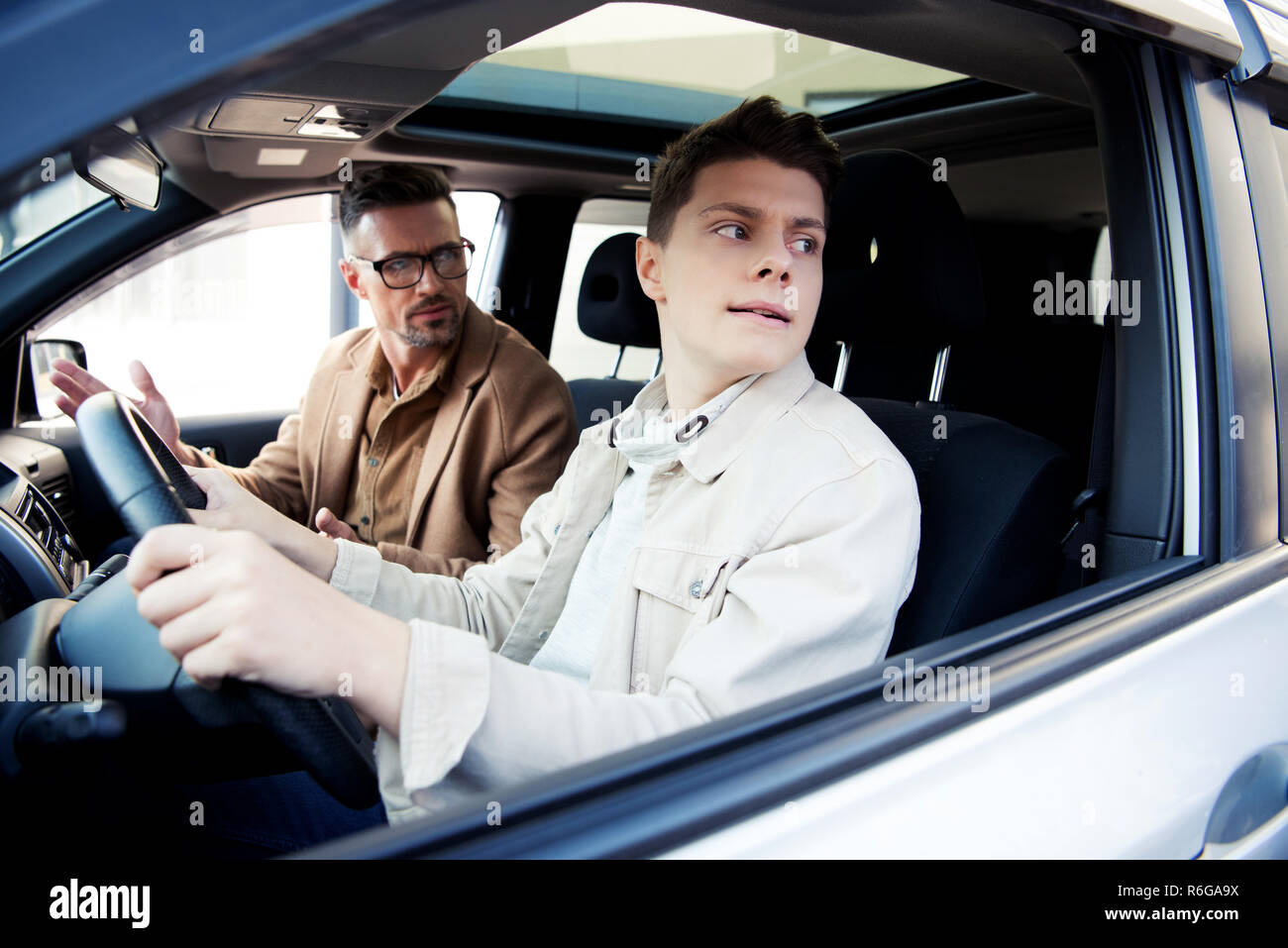 handsome father looking at teen son learning driving car Stock Photo ...
