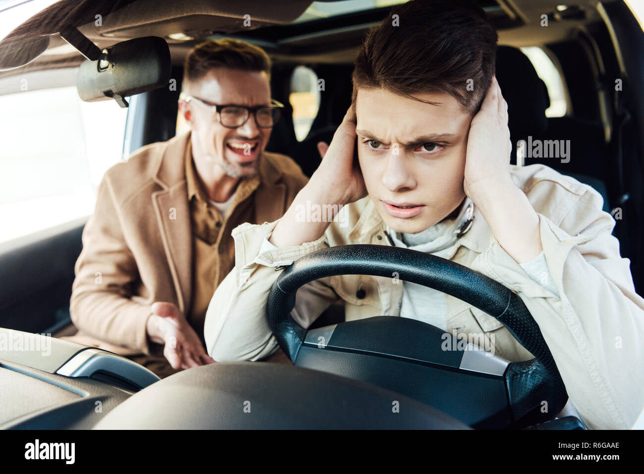 irritated father yelling at teen son in car Stock Photo - Alamy
