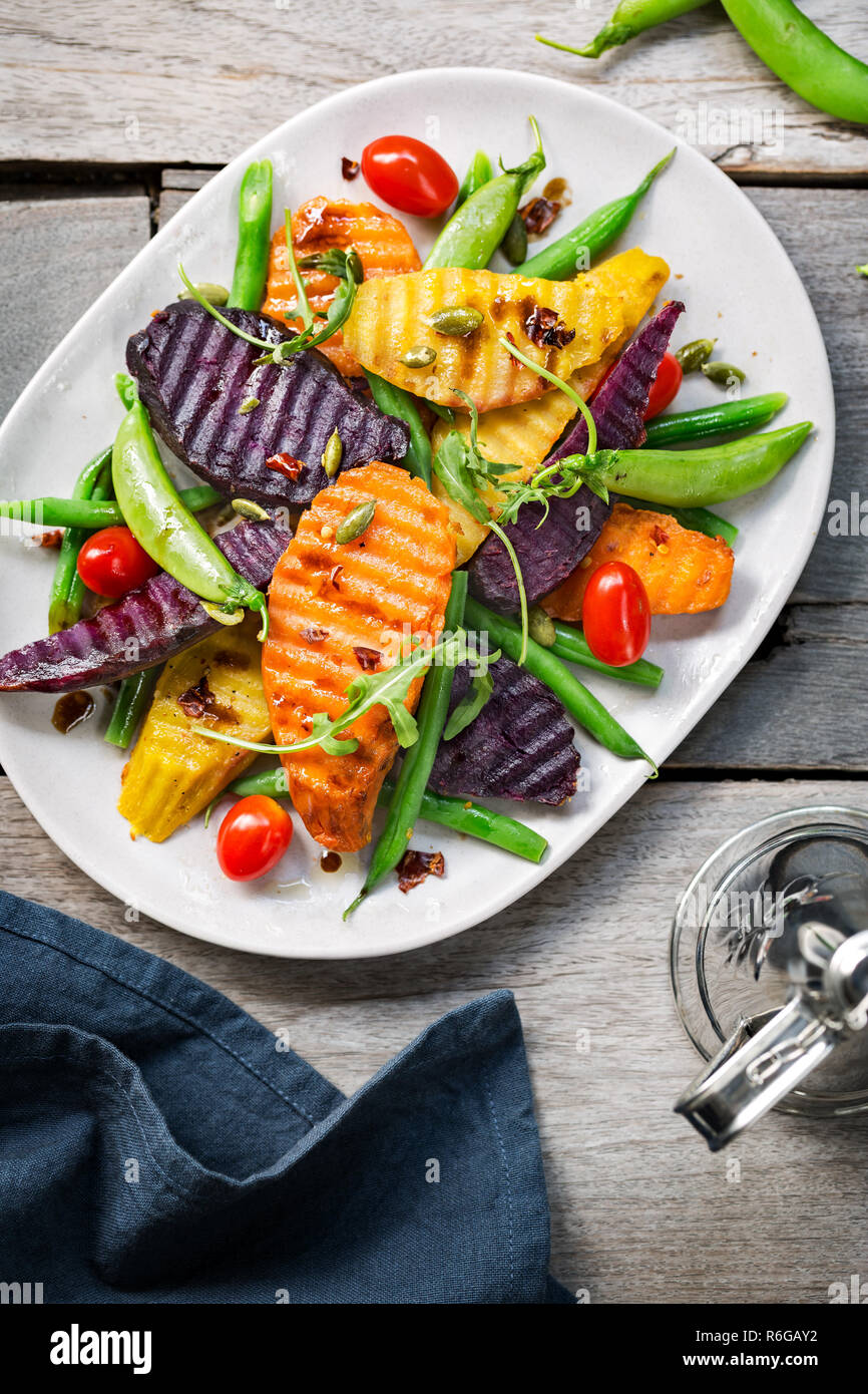 Grilled Sweet Potatoes with Snap pea and Rocket Stock Photo - Alamy