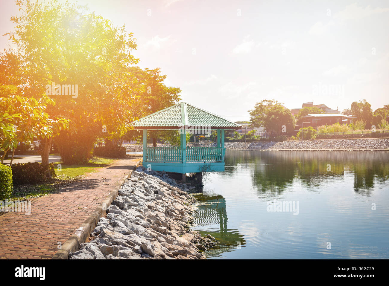 garden park with pavilion on river side in sunny day / waterfront ...