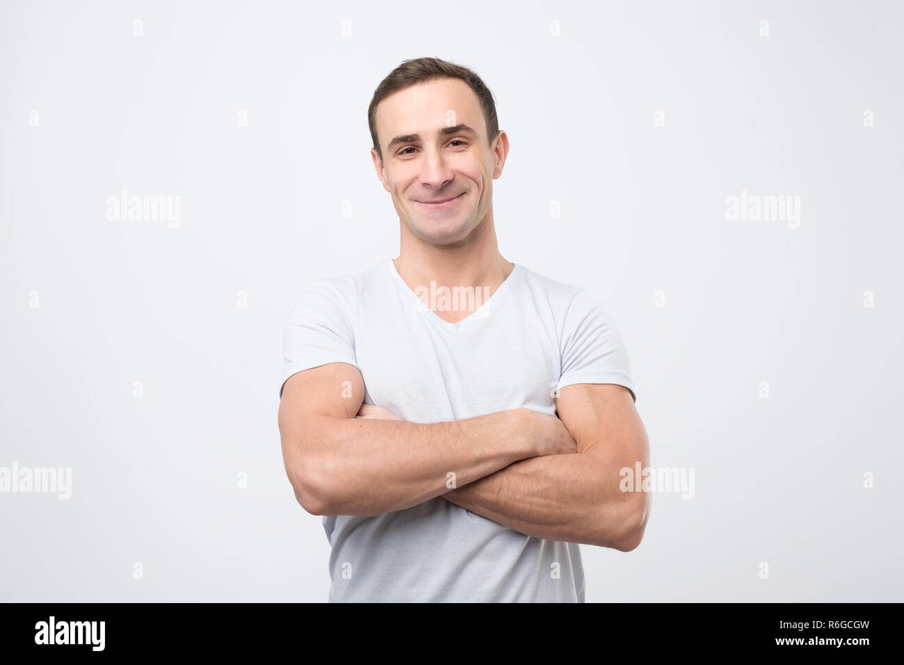 Guy standing crossed arms hi-res stock photography and images - Alamy