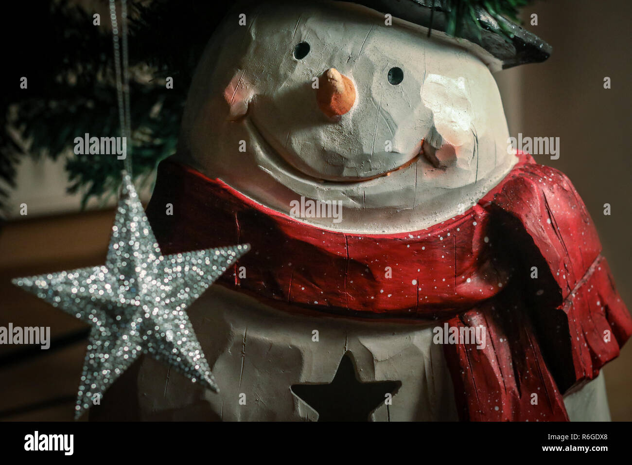 Snowman and shiny silver star under the christmas tree Stock Photo - Alamy