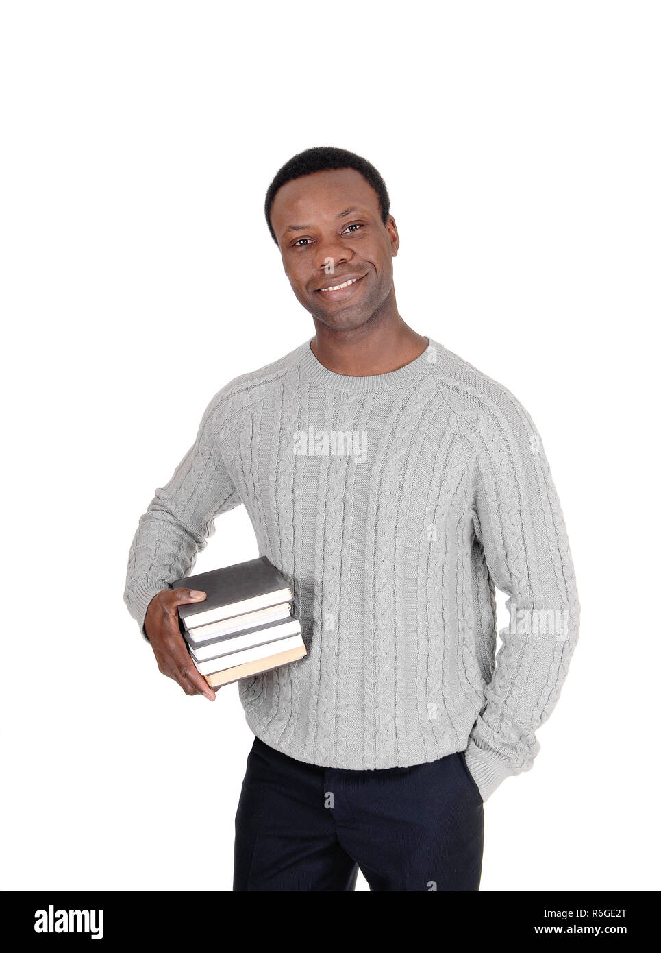 African man standing with books under his arms Stock Photo - Alamy