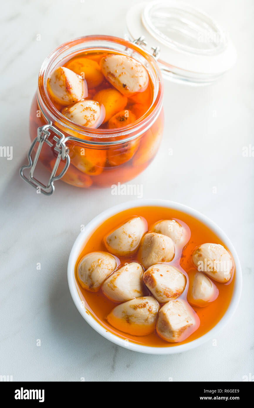 Tasty preserved garlic Stock Photo - Alamy