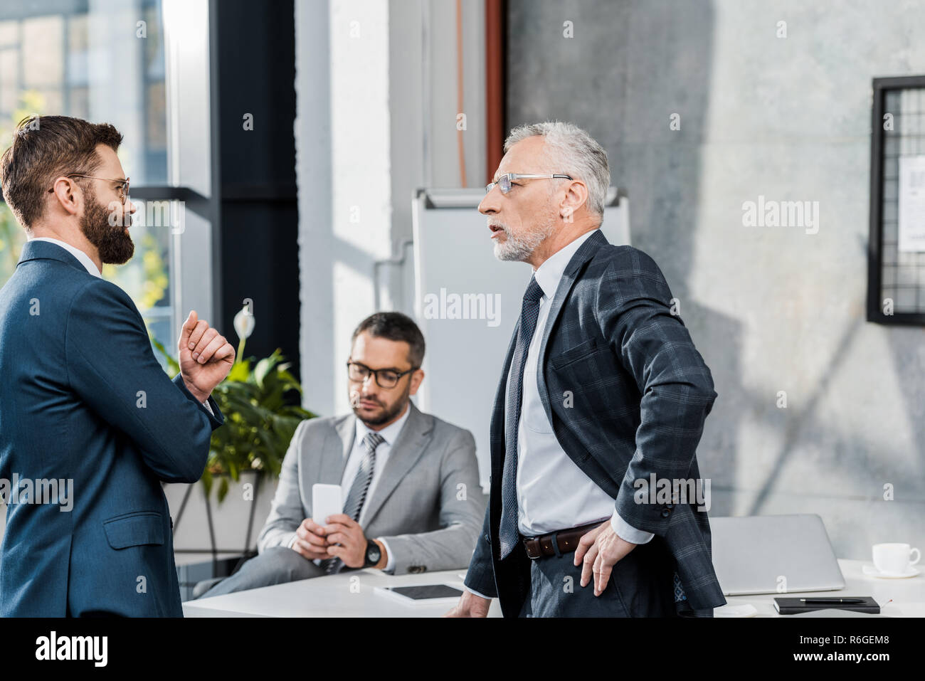 Businessmen standing side side looking hi-res stock photography and ...