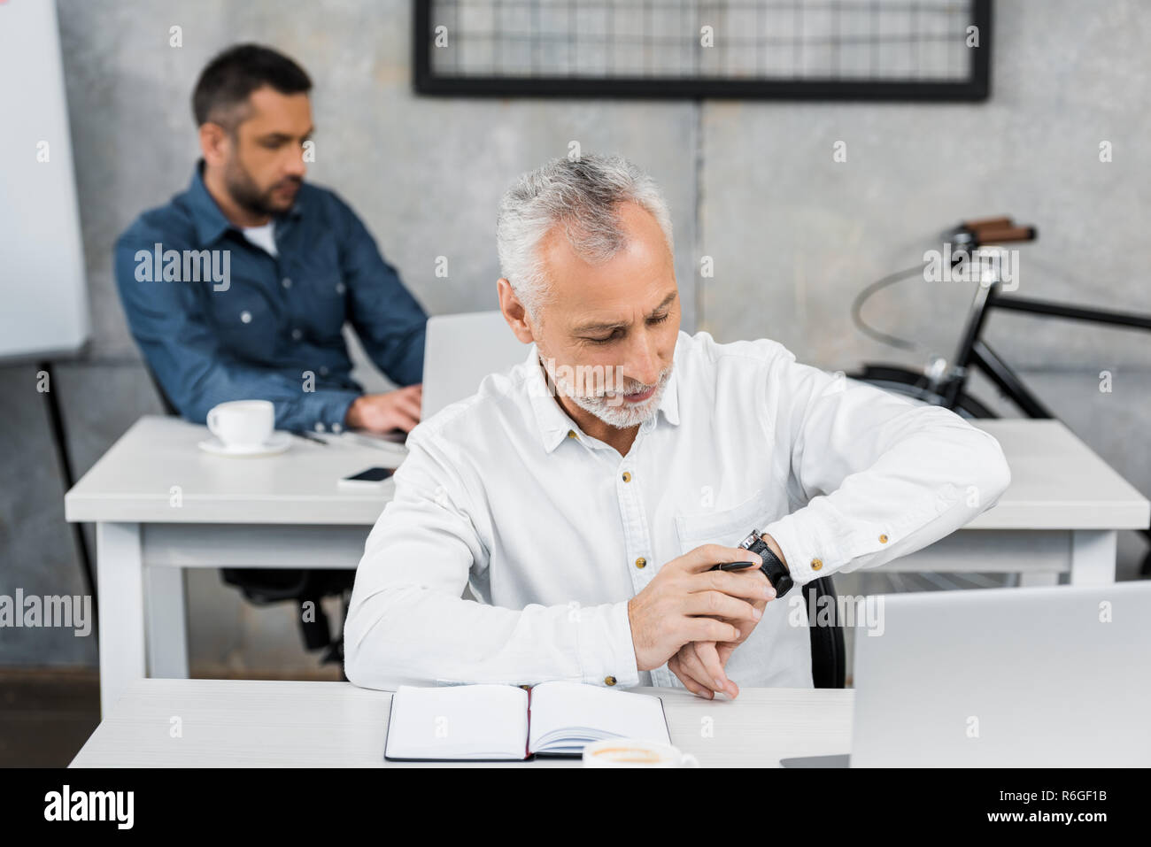 Businessmen checking the time hi-res stock photography and images - Alamy