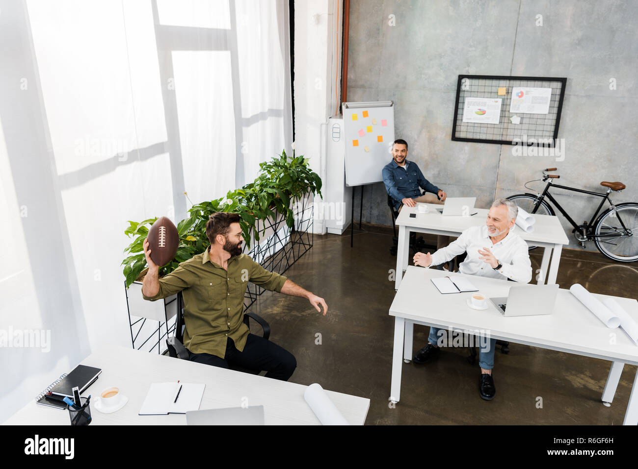 high angle view of handsome businessmen having fun in office Stock ...