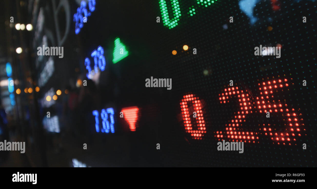 Stock market graph showing prices on window screen at night Stock Photo ...