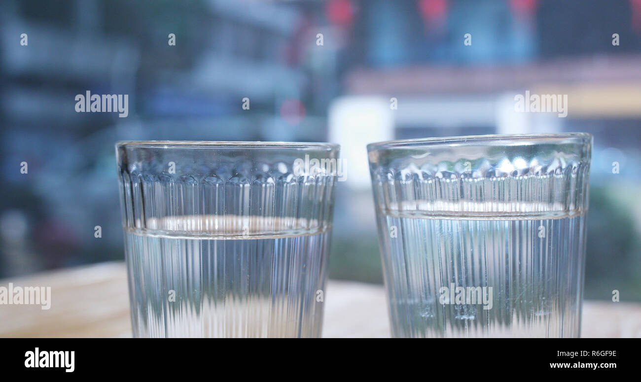 Two glass of water glass with city background Stock Photo - Alamy