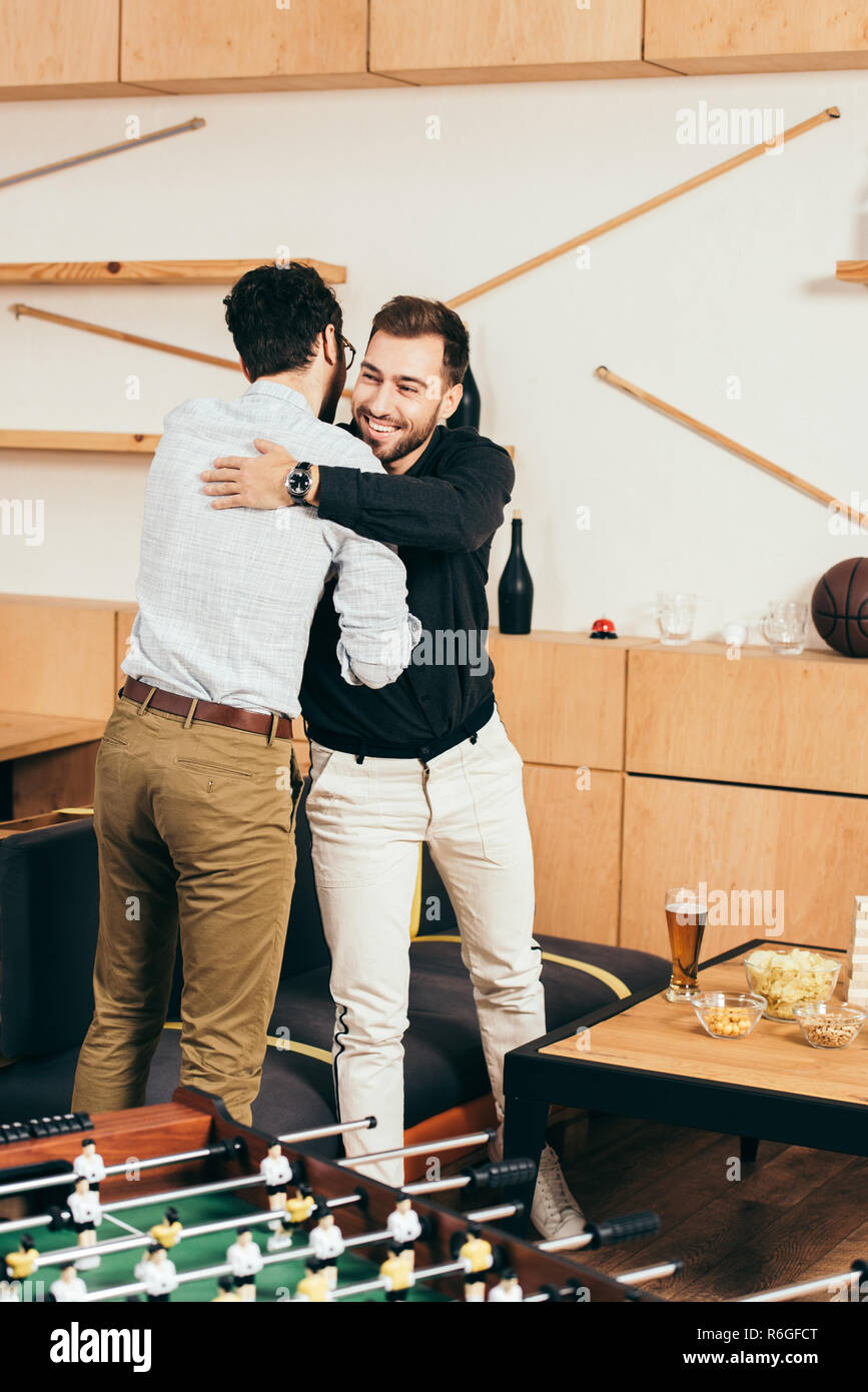 Football hugging men hi-res stock photography and images - Alamy