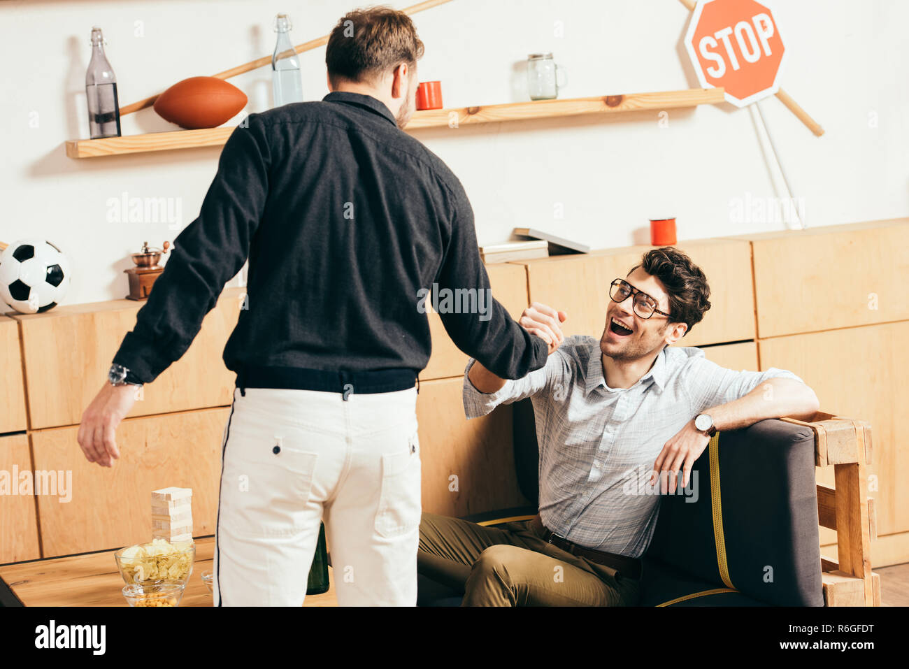 happy men shaking hands while greeting each other in cafe Stock Photo ...