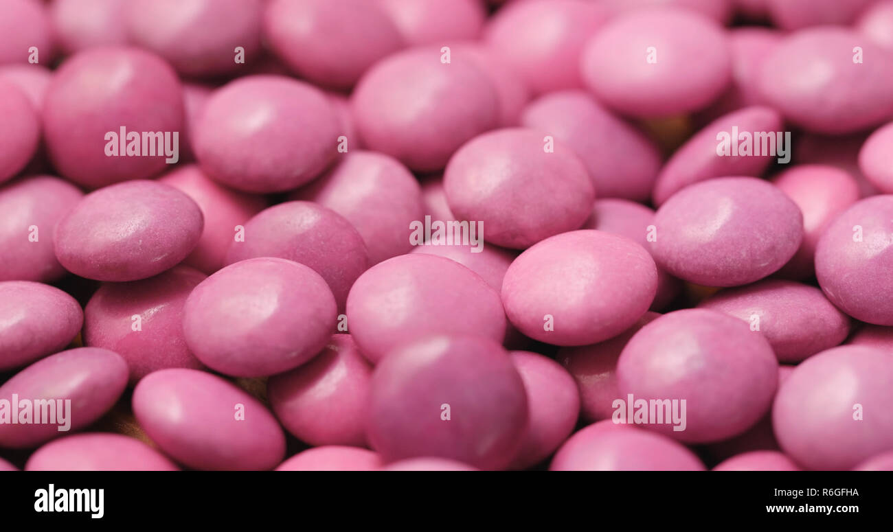 Chocolate bean in pink Stock Photo - Alamy