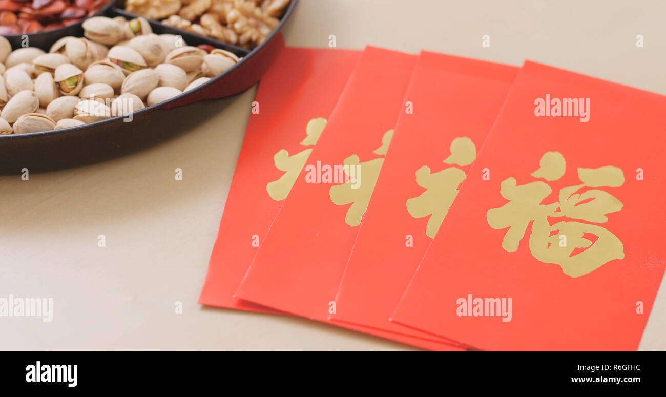 Chinese red pocket with a word luck and assorted snack box Stock Photo ...