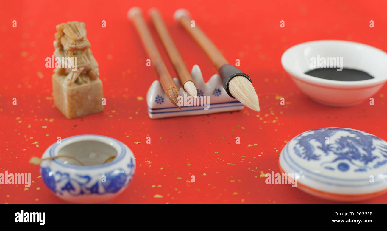 Chinese calligraphy writing tool on red paper Stock Photo - Alamy