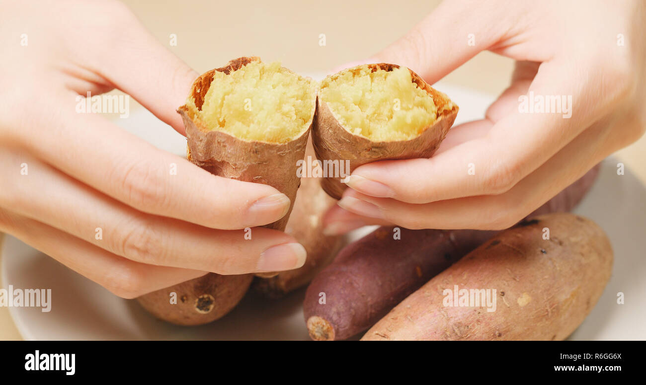 Hand tear grilled sweet potato Stock Photo - Alamy