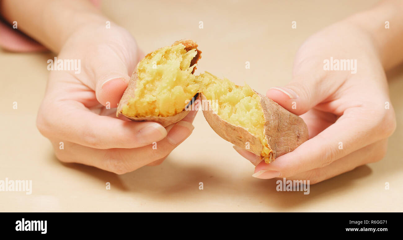 Hand tear sweet potato Stock Photo - Alamy