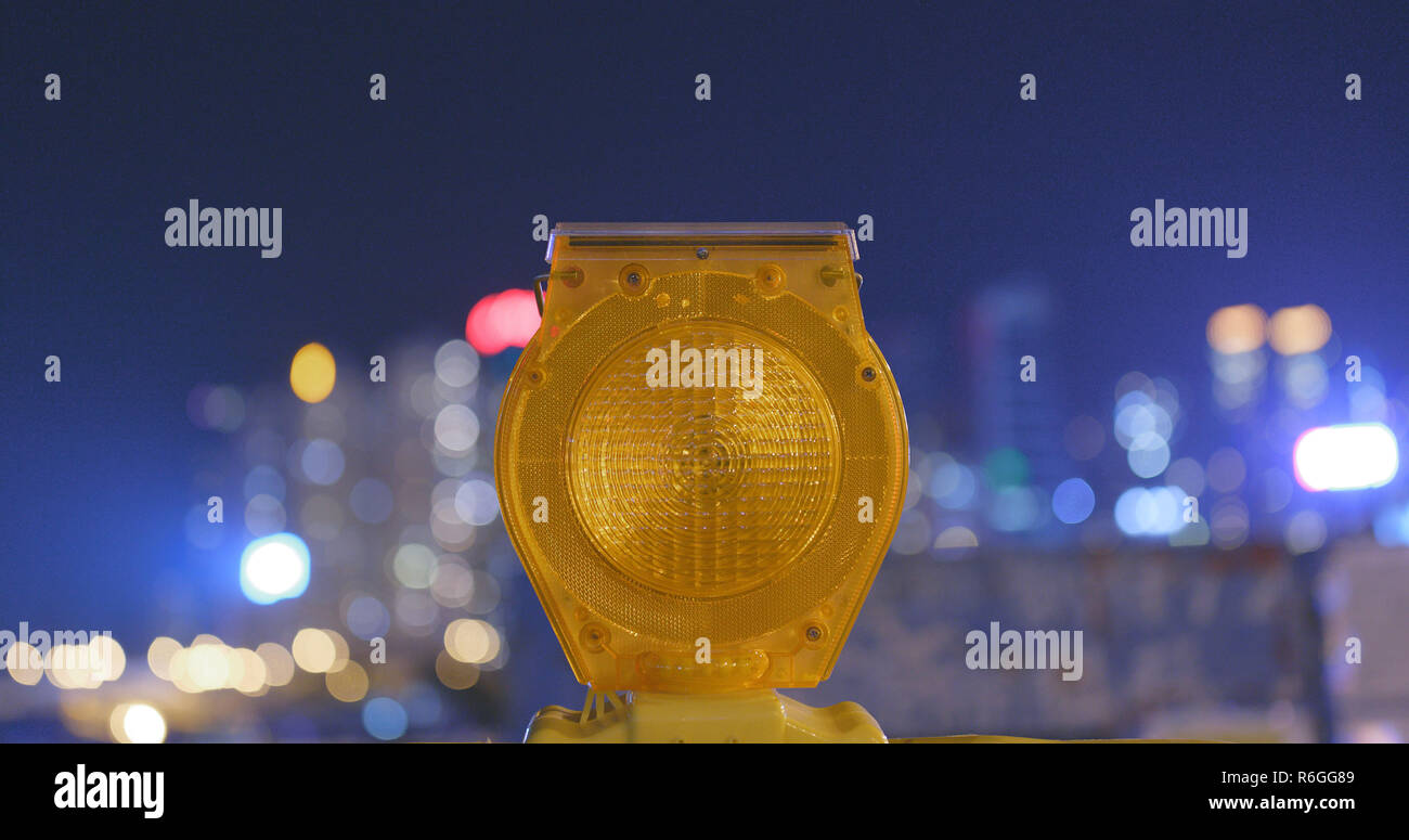 Caution yellow light in the city at night Stock Photo - Alamy