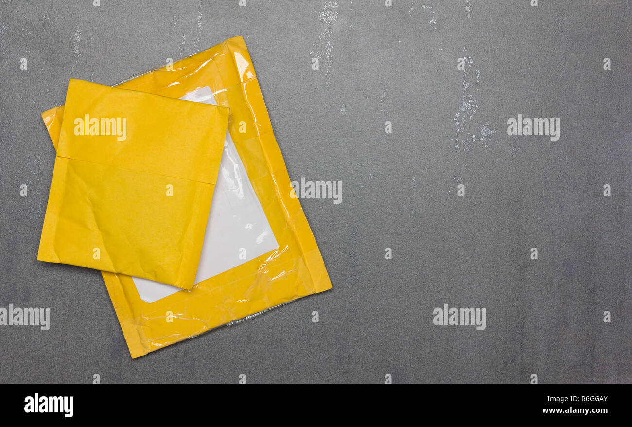 yellow paper bags from Chinese online stores on grey background, top ...