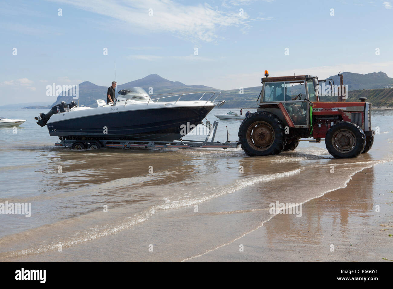 A tractor is used to retrieve and to launch small boats on the Llyn ...