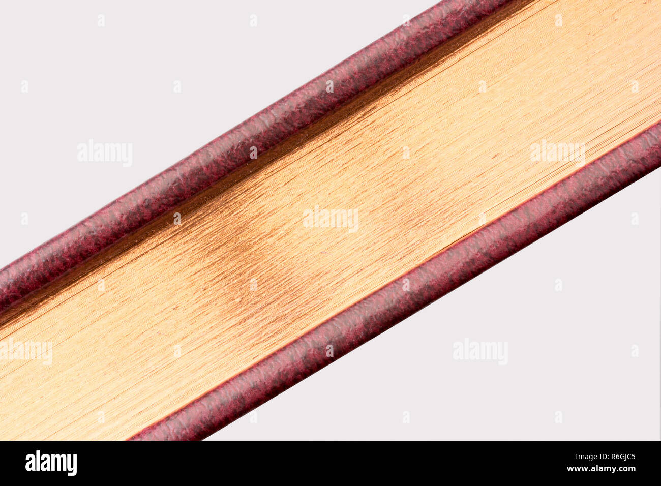 gilded edge of the book on a gray background close-up on a diagonal ...