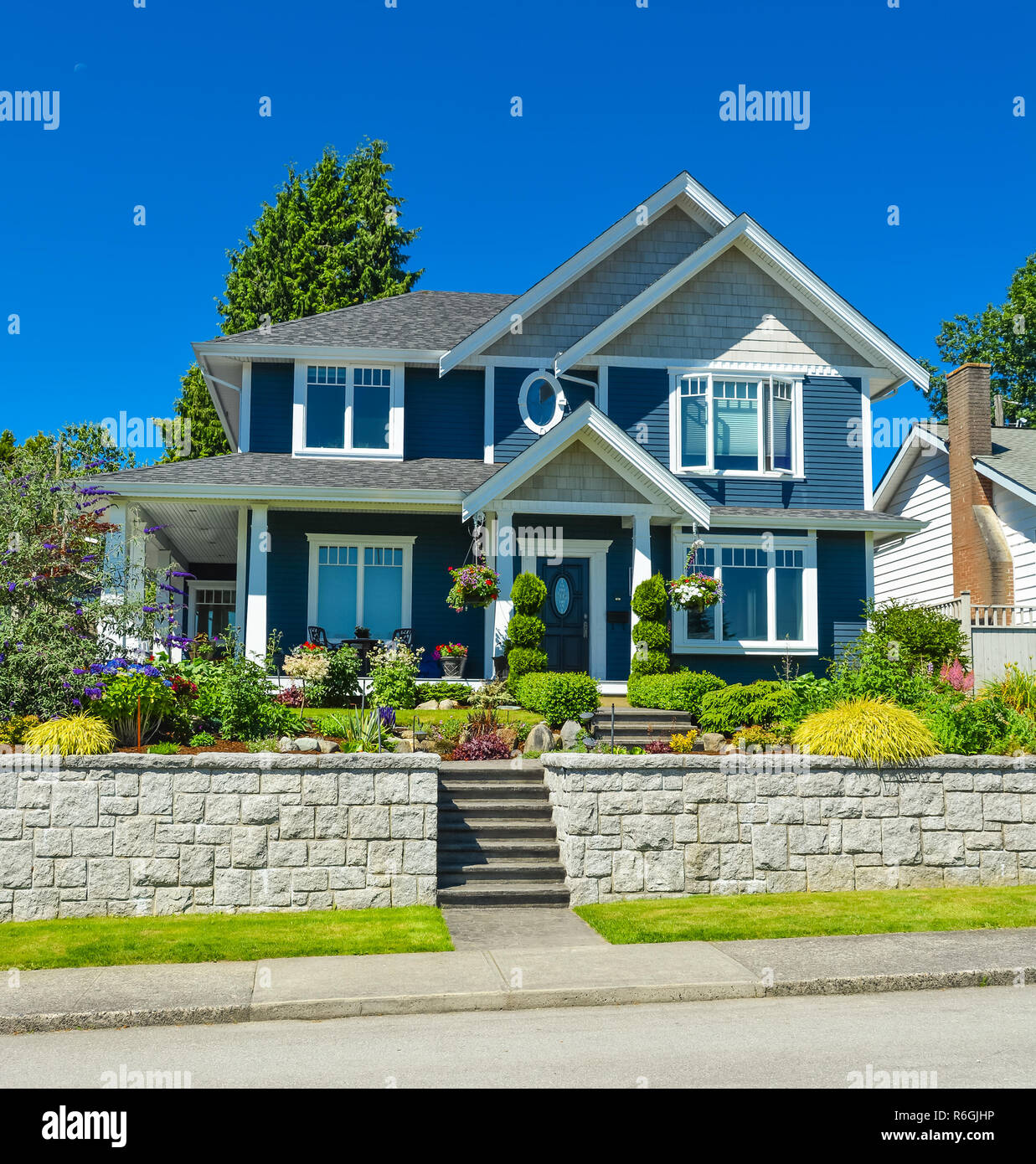 Luxury family house with landscaped front yard on land terrace Stock ...