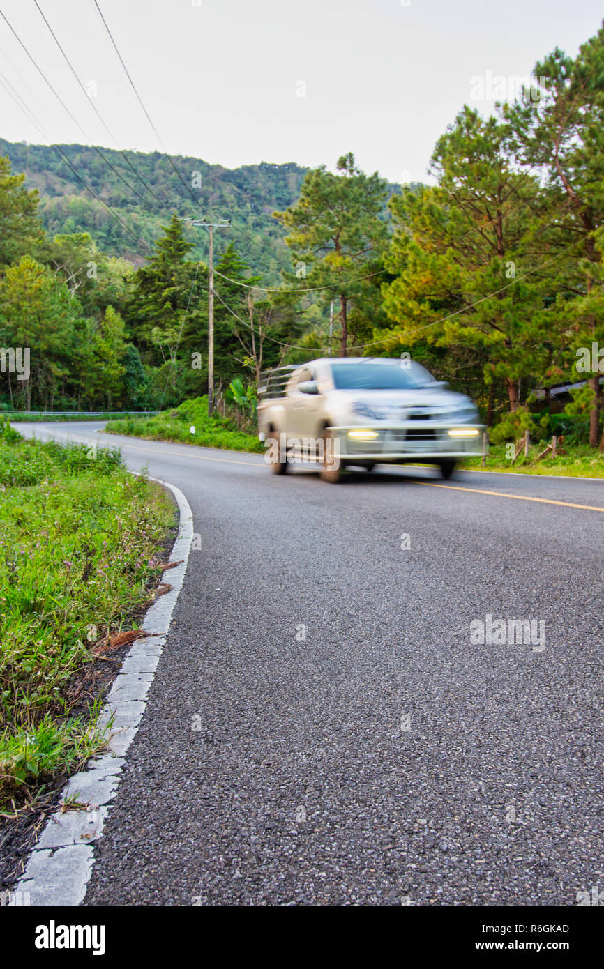 Car Driving Down Winding Road