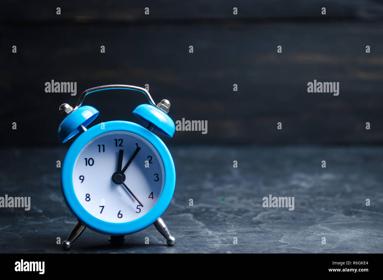 The blue alarm clock indicates the beginning of the first on a black ...