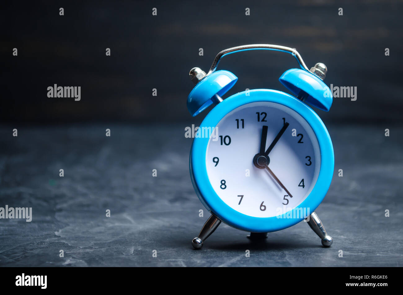 The blue alarm clock indicates the beginning of the first on a black ...