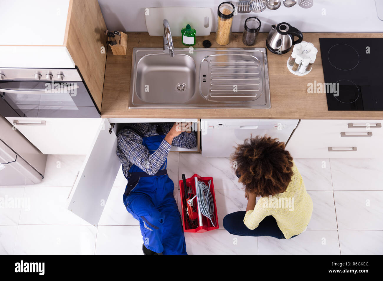 Plumbing job under kitchen sink hi-res stock photography and images - Alamy