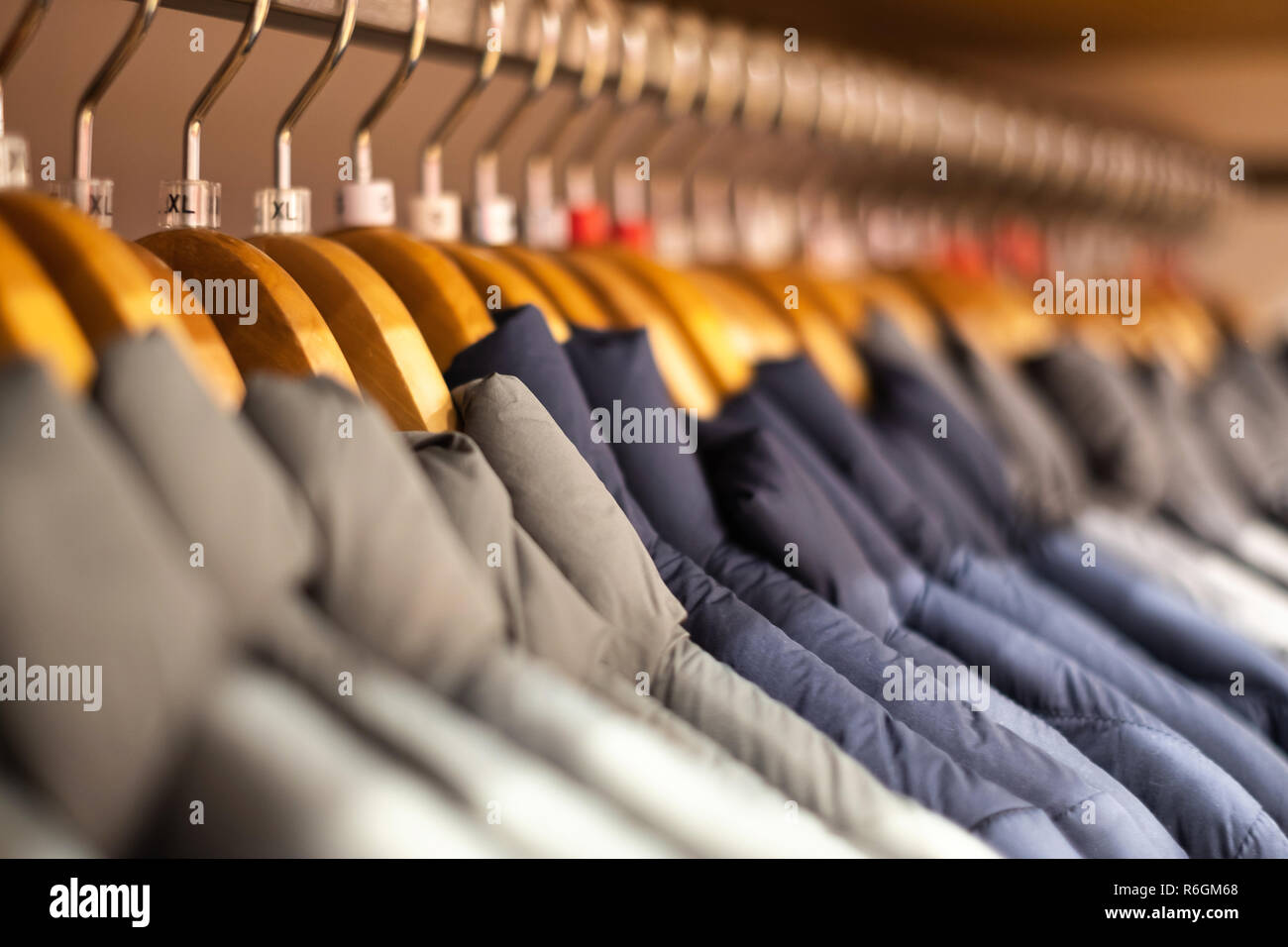 A new collection of cloths hanging on hangers in the store shop Stock ...