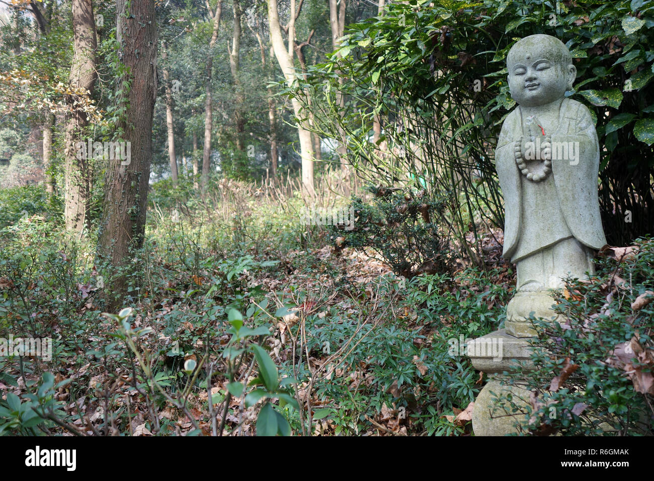 Statue of a cute little Buddha Stock Photo - Alamy