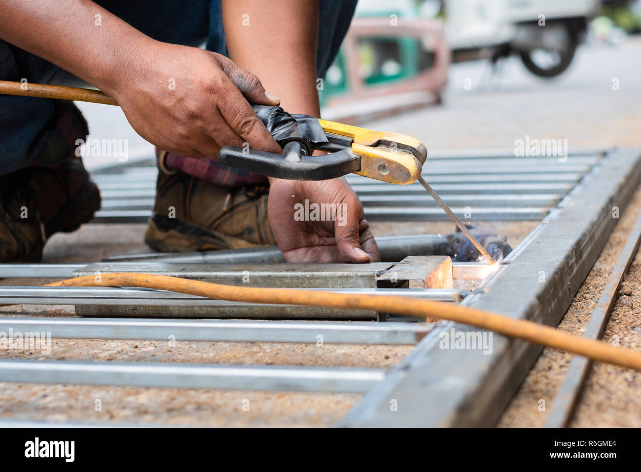 A welder is welding steel for house's fence Stock Photo - Alamy