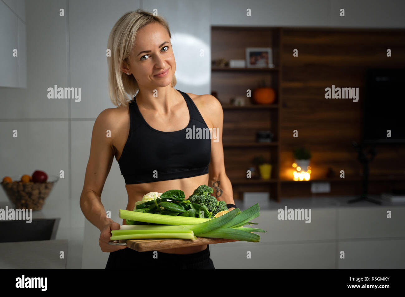 a sporty girl with set of green vegetables Stock Photo - Alamy