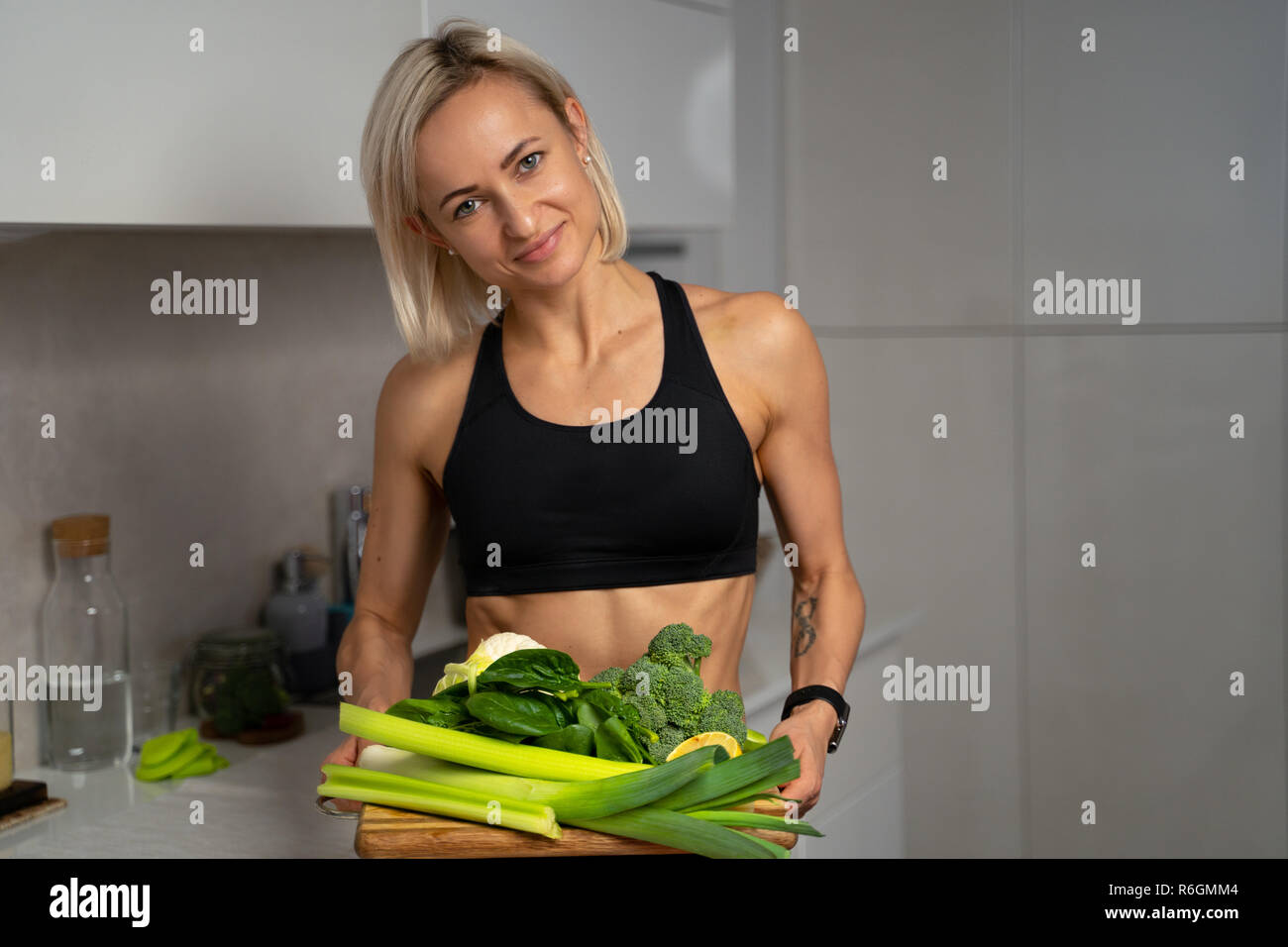 a sporty girl with set of green vegetables Stock Photo - Alamy