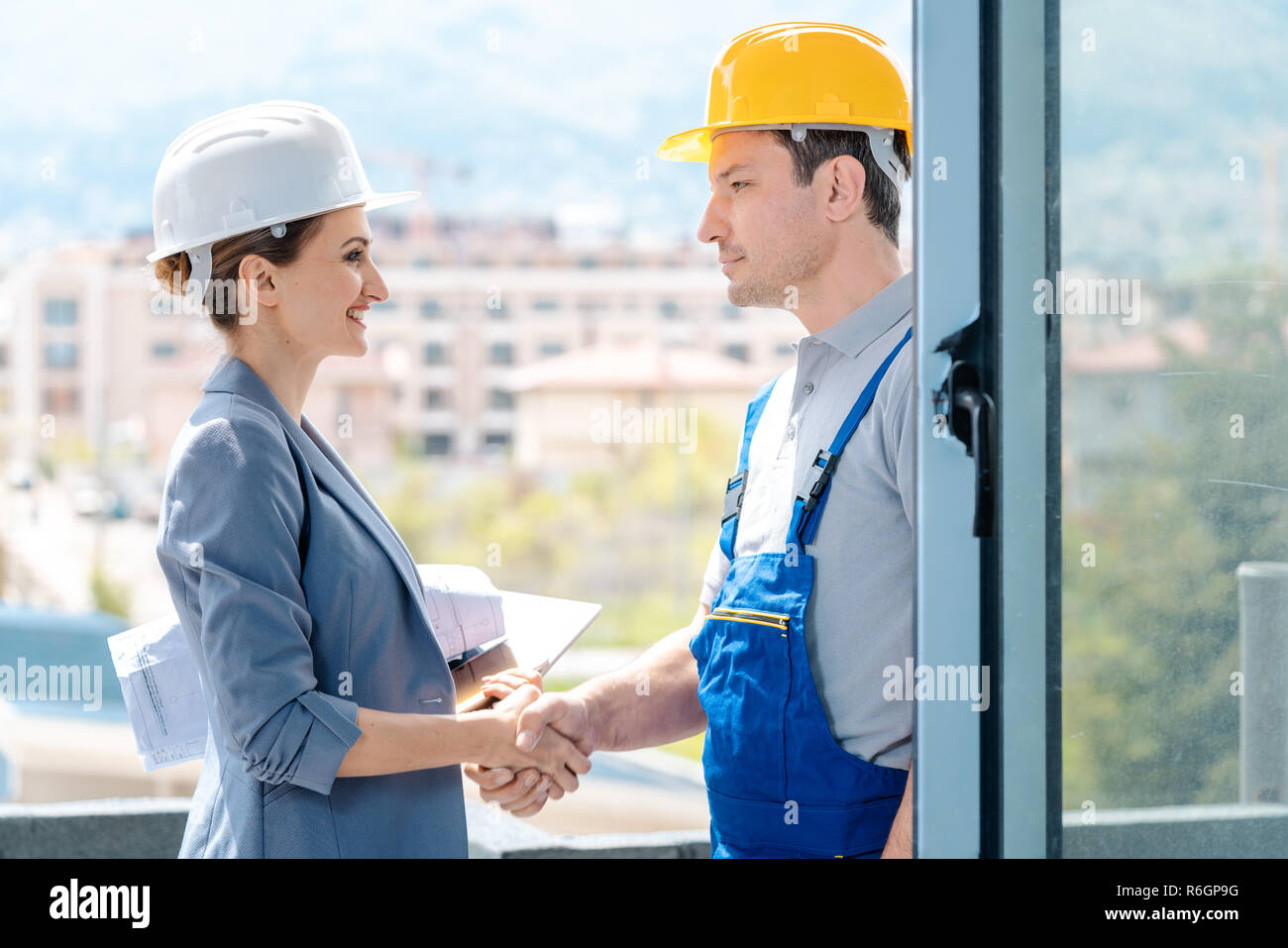 Handshake on construction site between developer and builder Stock ...