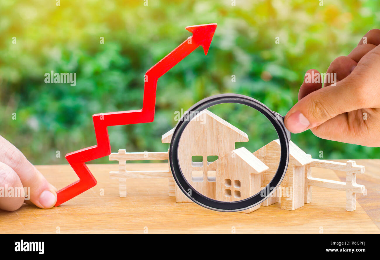 wooden house with a red arrow up. concept of high demand for real ...