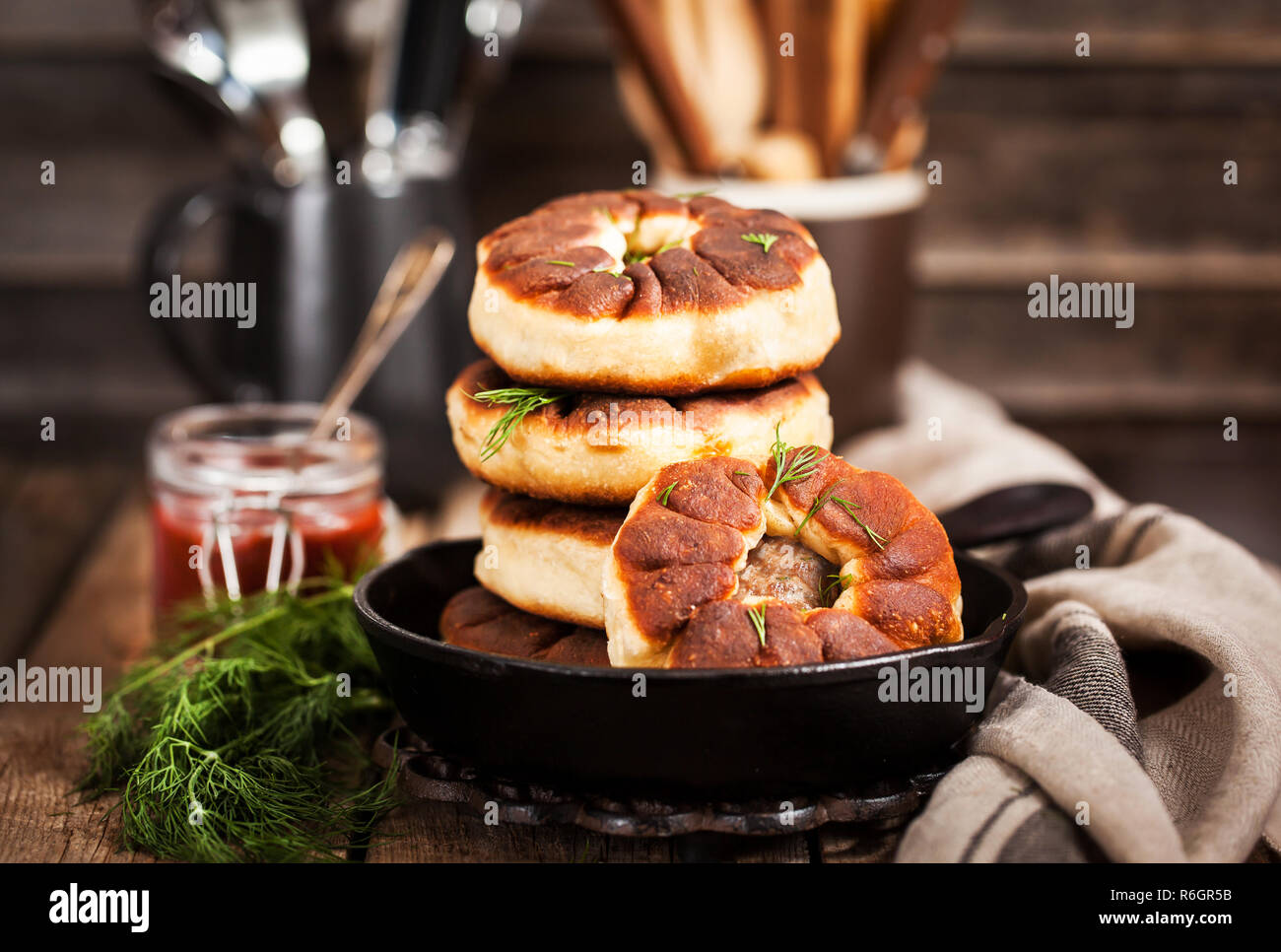 Traditional Russian deep fried meat patties (belyash) on rustic ...
