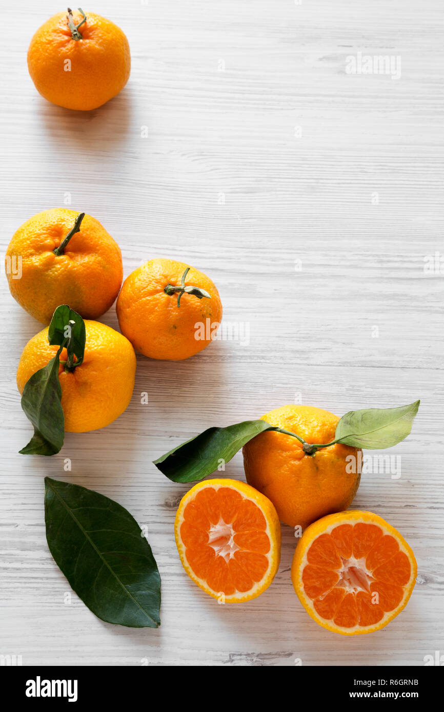 Top view, fresh ripe tangerines over white wooden background. Flat lay ...